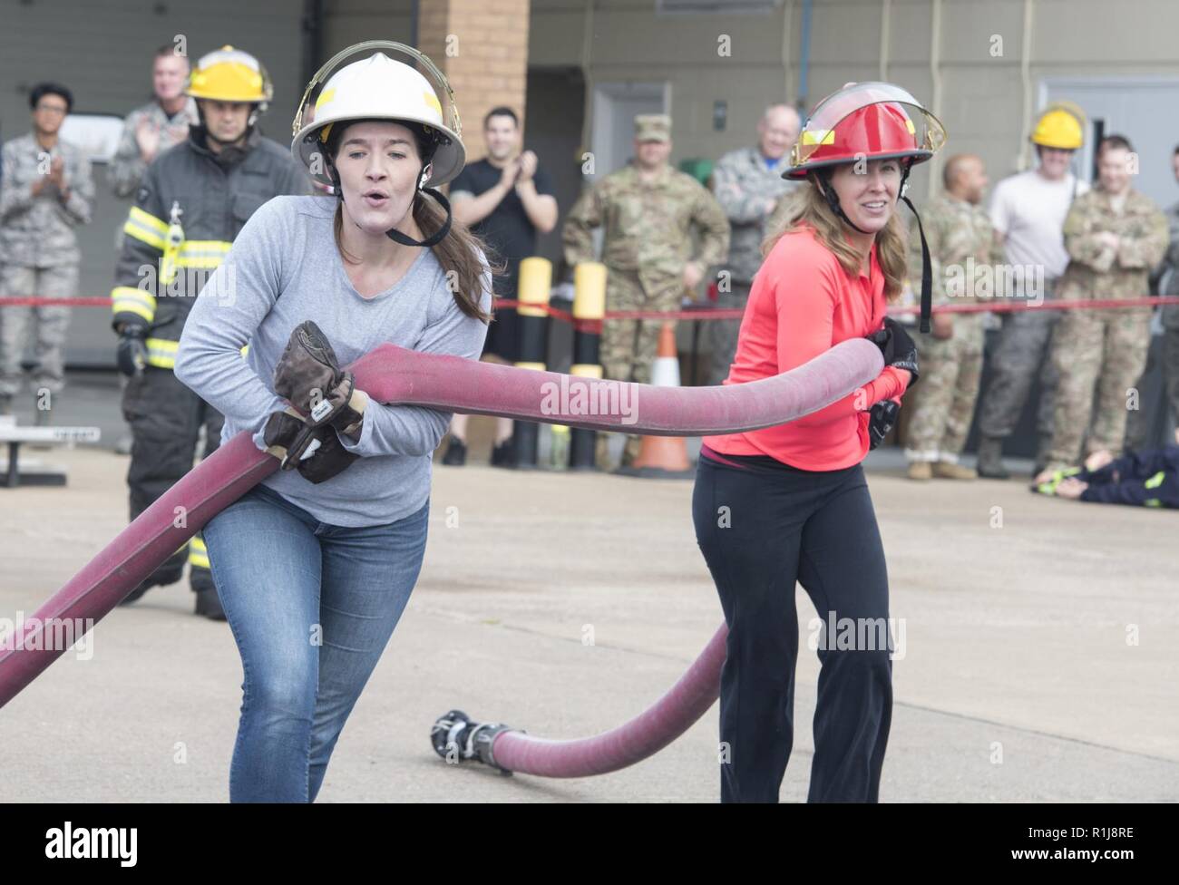 Firefighter Challenge contestants pull a fire hose at RAF Croughton ...