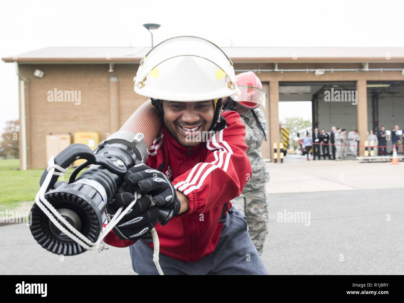 Firefighter Challenge contestants pull a fire hose at RAF Croughton ...