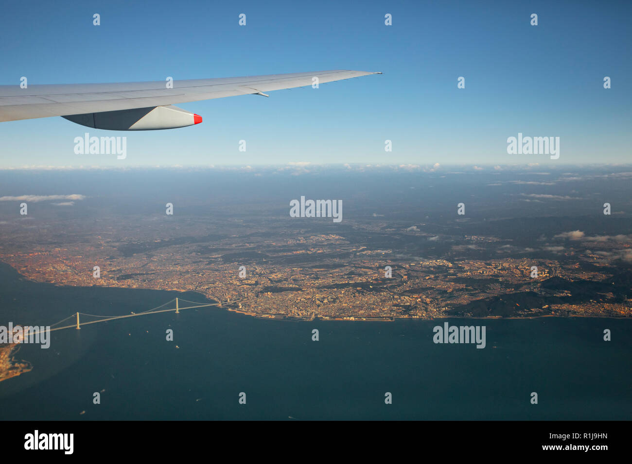 aerial view from plane window over Akashi-Kaikyo Bridge crossing osaka ...