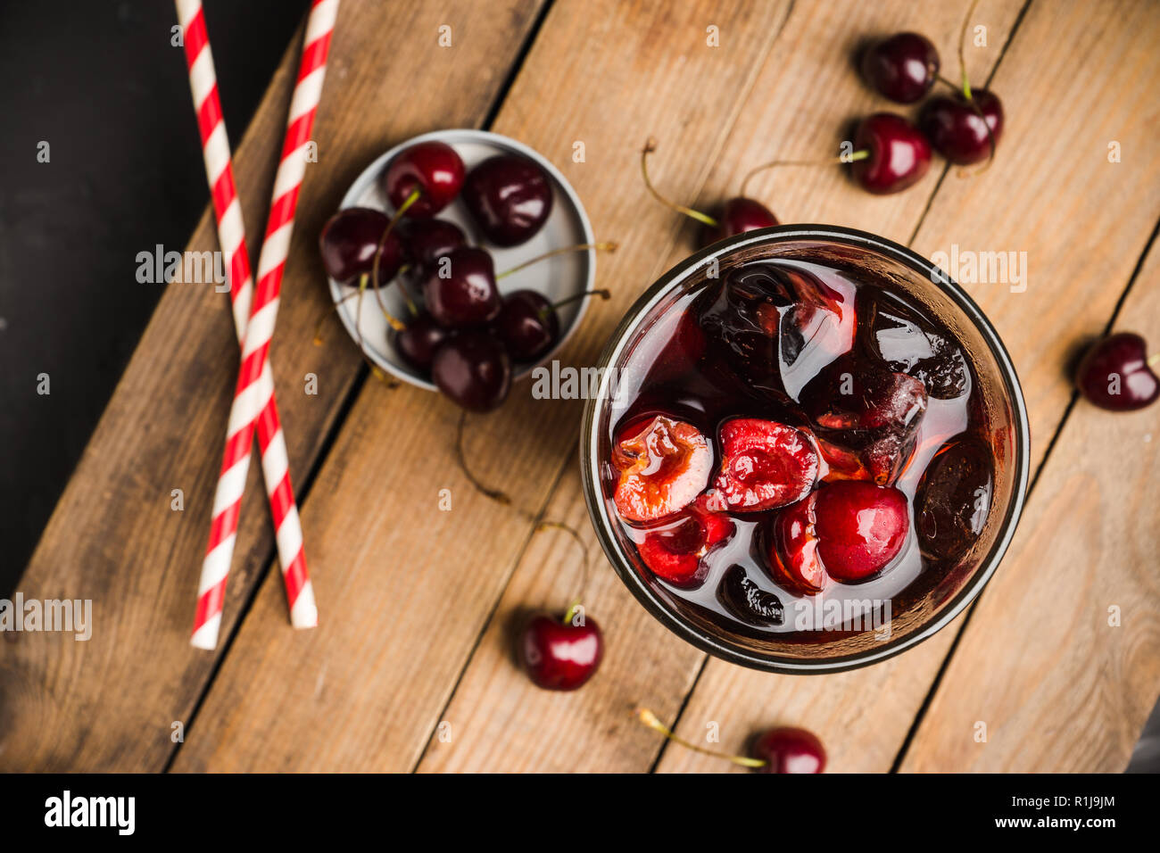 Refreshing cold cherry cola on the wooden background Stock Photo - Alamy