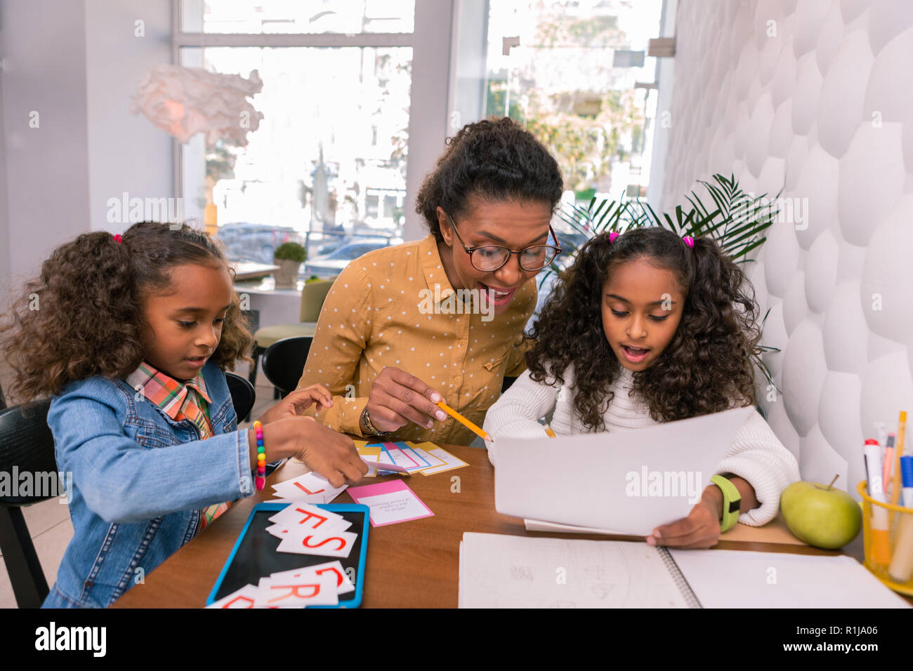 Caring teacher hi-res stock photography and images - Alamy