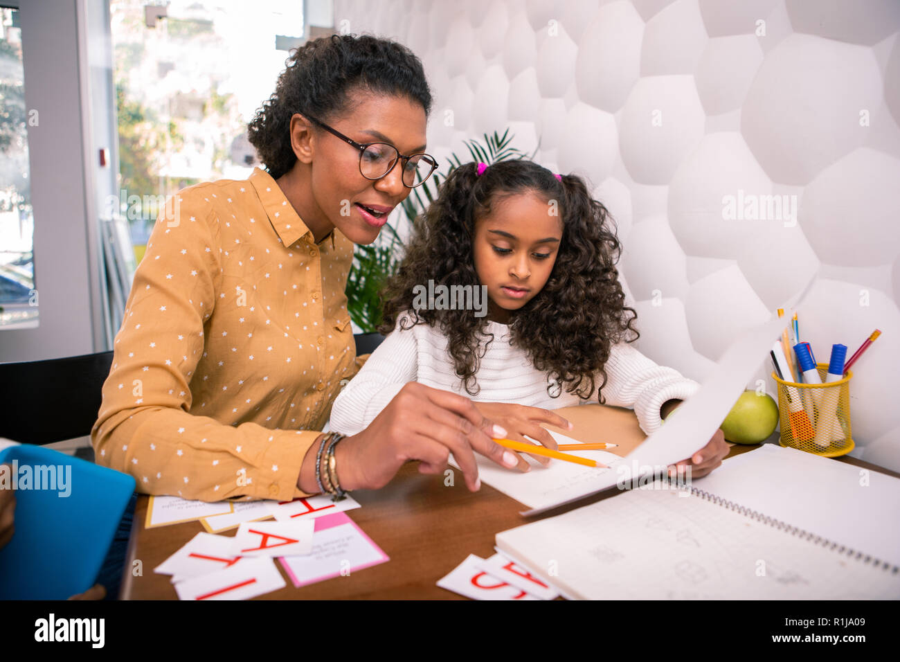 Caring teacher hi-res stock photography and images - Alamy