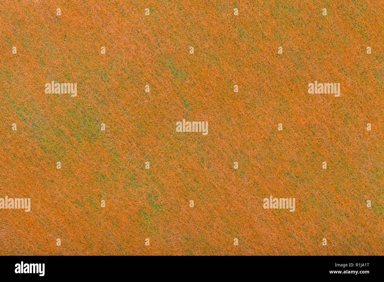 Construction of a bright orange background with light green spots of ...