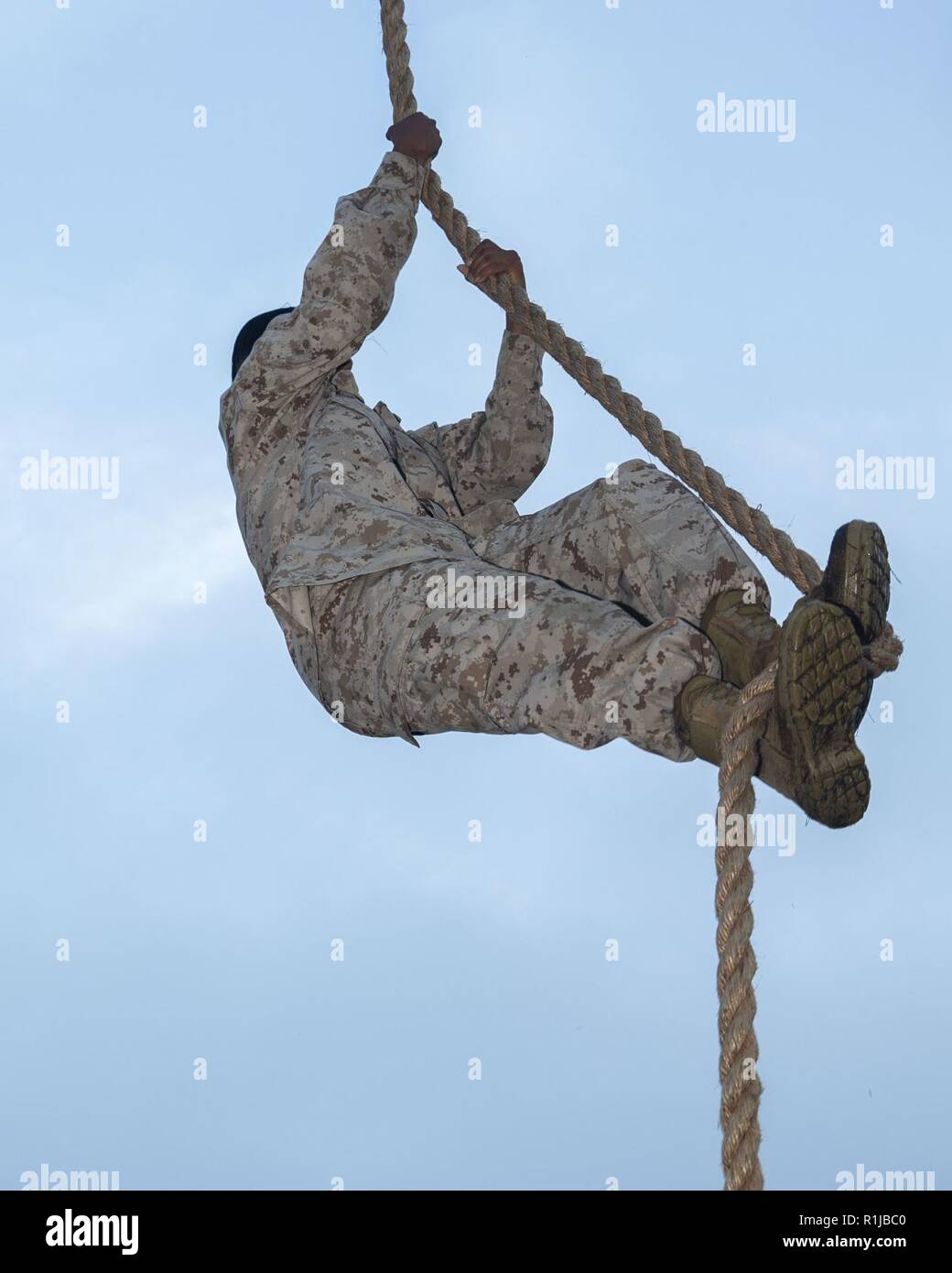 U. S. Marine officer candidates participate in an obstacle course event ...