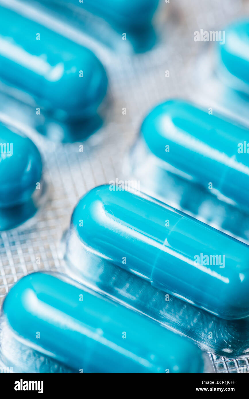 Blue medical capsules hi-res stock photography and images - Alamy