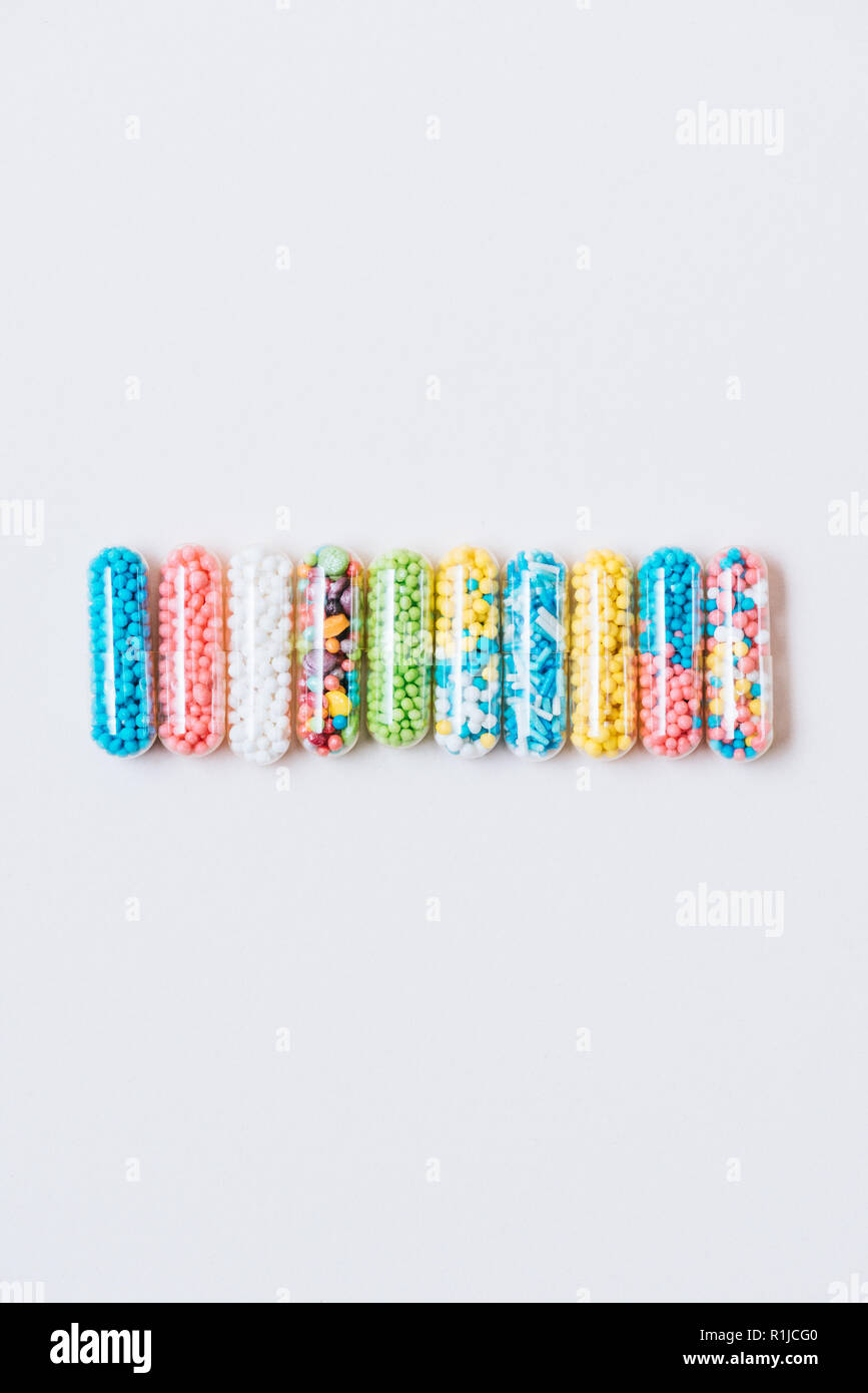 top view of row of various colorful medical capsules on white Stock ...