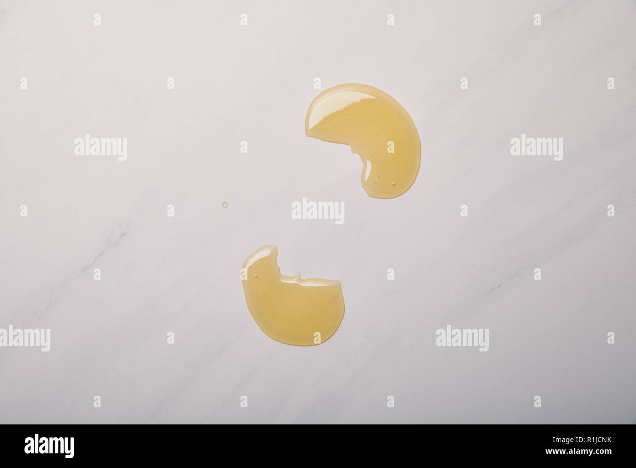 top view of spilled yellow soap on white marble Stock Photo - Alamy