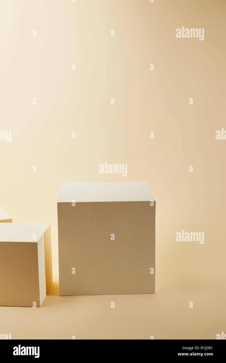 cubes in various sizes on beige surface Stock Photo - Alamy
