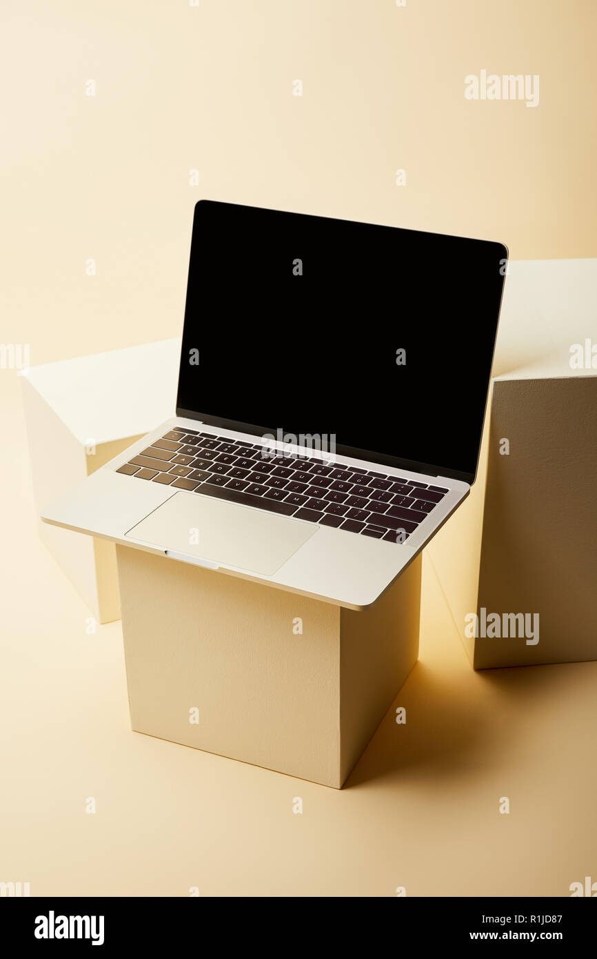 close-up shot of modern laptop with blank screen on beige cubes Stock ...