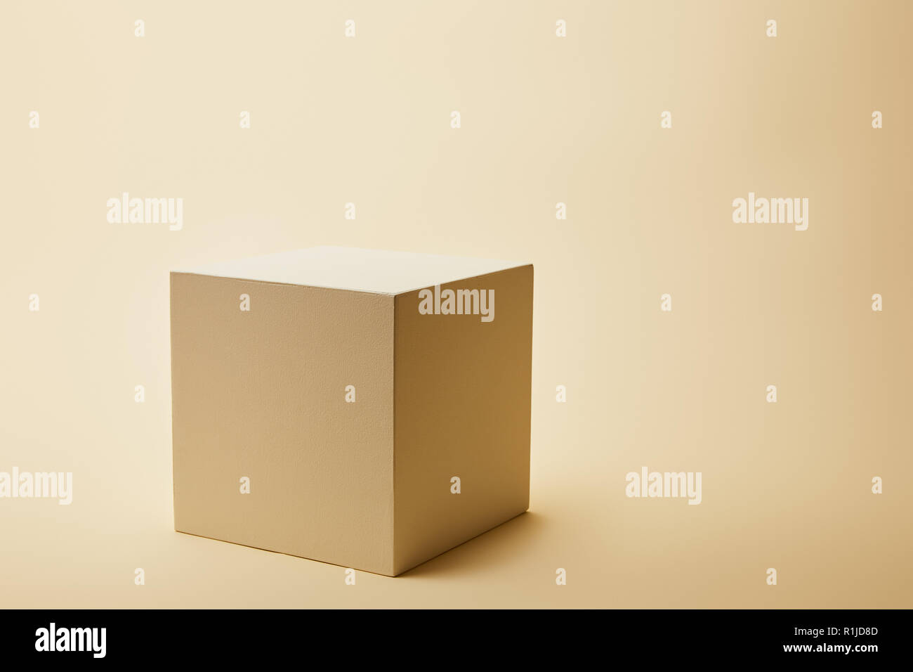close-up shot of single cube on beige surface Stock Photo - Alamy