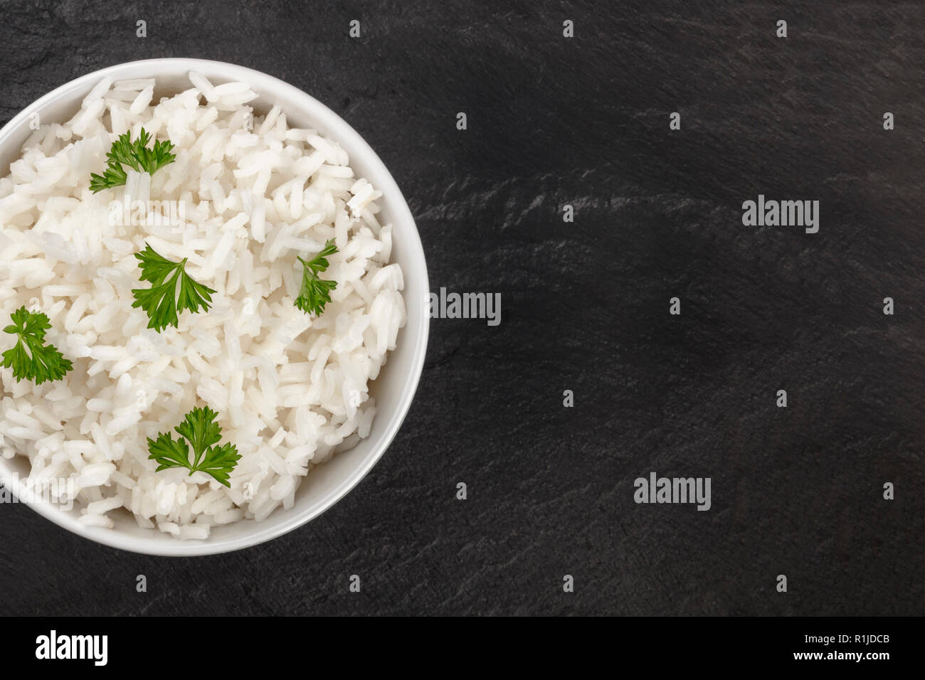 An overhead closeup photo of a bowl of cooked white long rice, shot ...