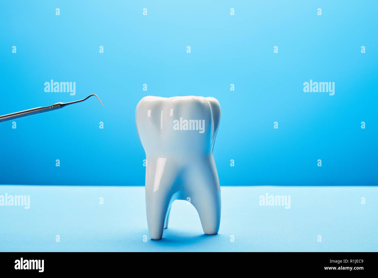 close up view of tooth model and dental probe on blue background Stock ...