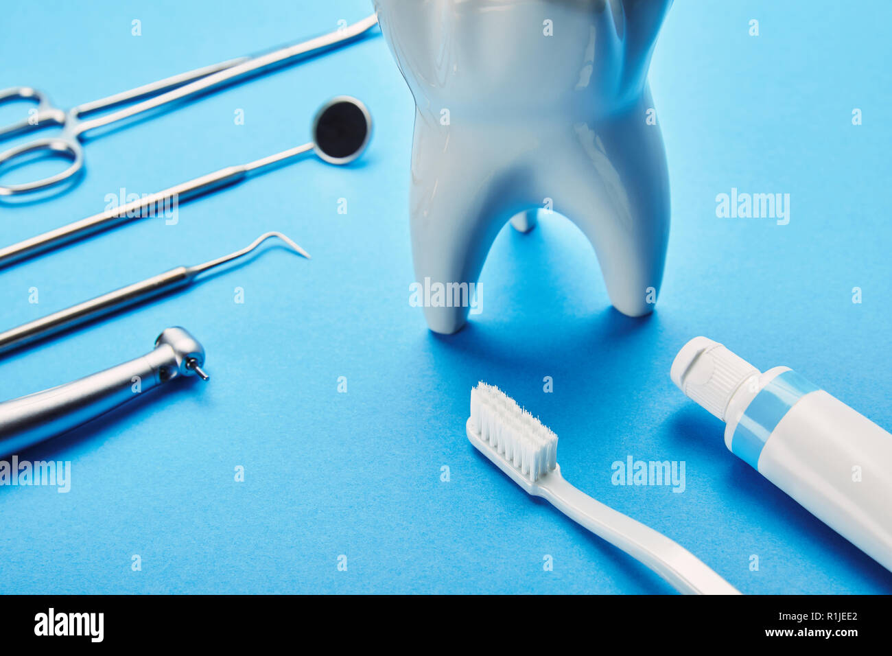 close up view of white tooth model, toothbrush, toothpaste and ...