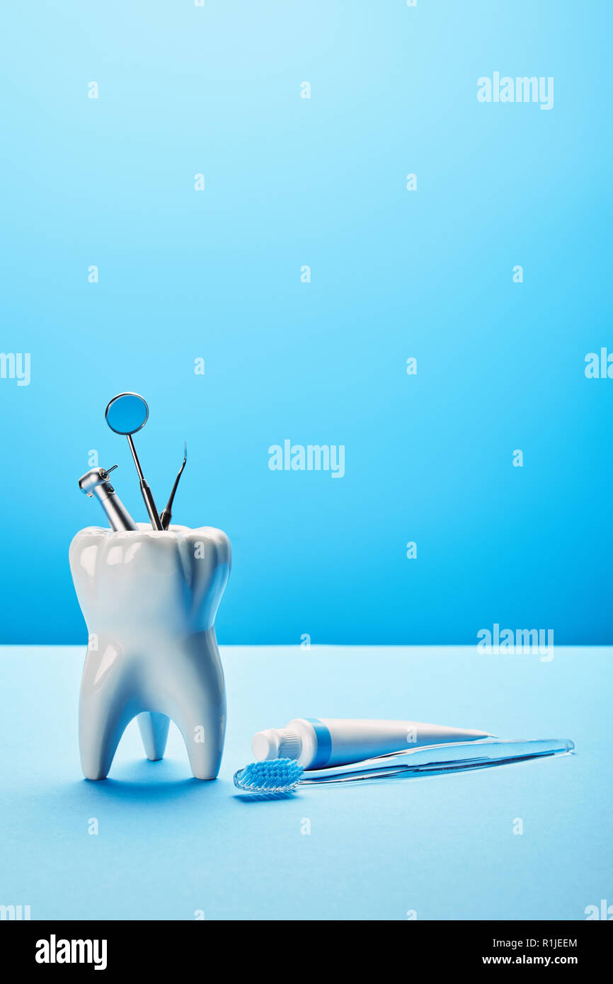 close up view of white tooth model, toothbrush, toothpaste and ...