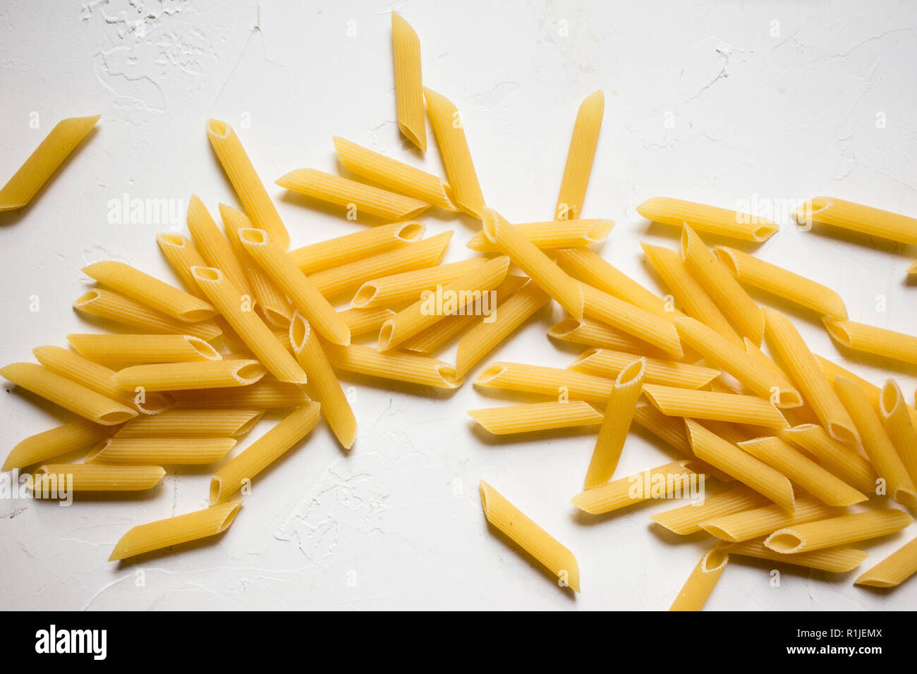 Italian Penne Rigate Macaroni Pasta raw food background Stock Photo - Alamy