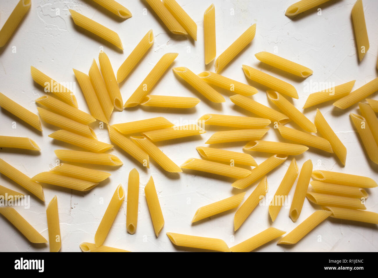 Italian Penne Rigate Macaroni Pasta raw food background Stock Photo - Alamy