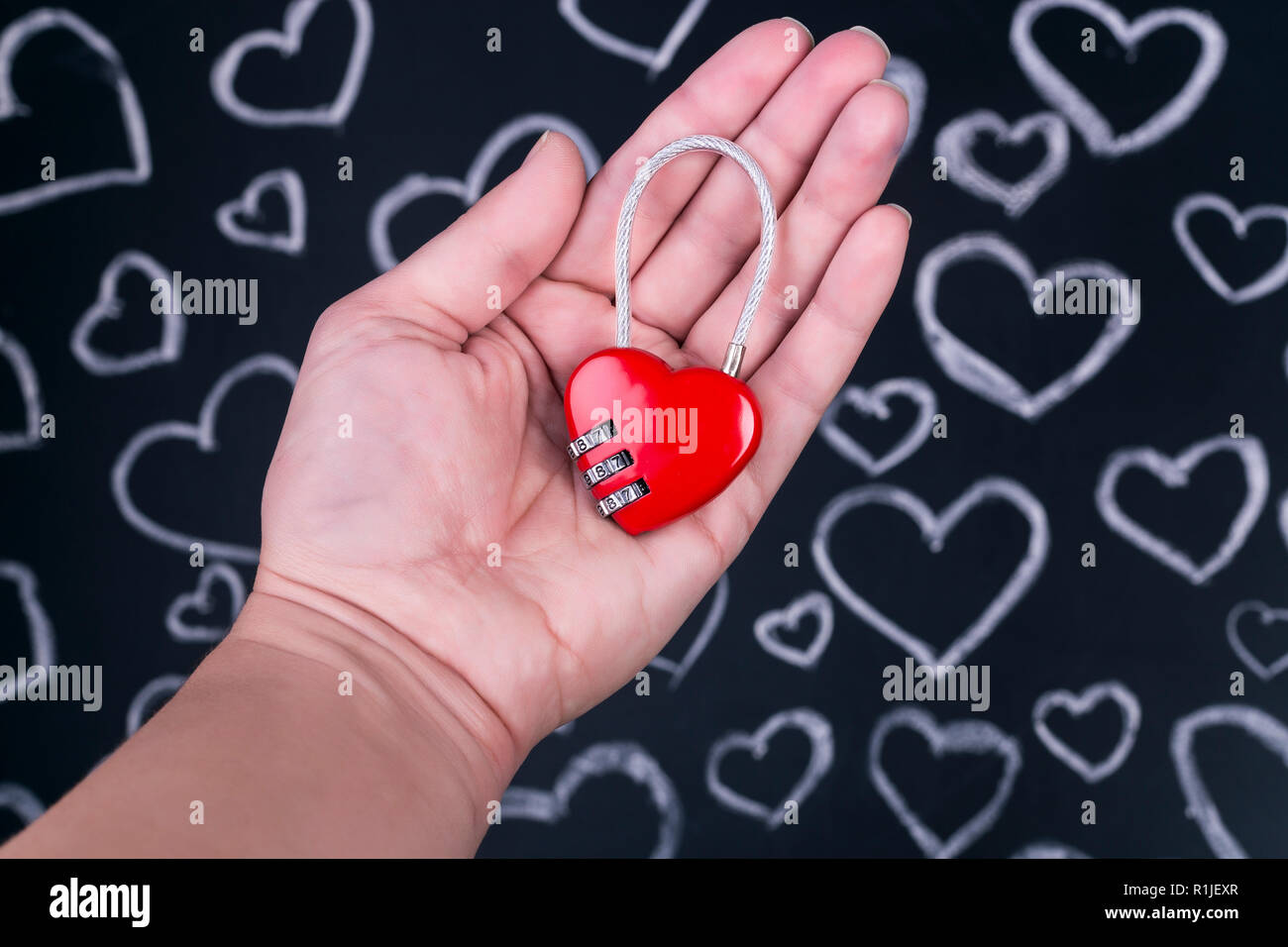 lock in the form of a heart with a password on the hand against the ...
