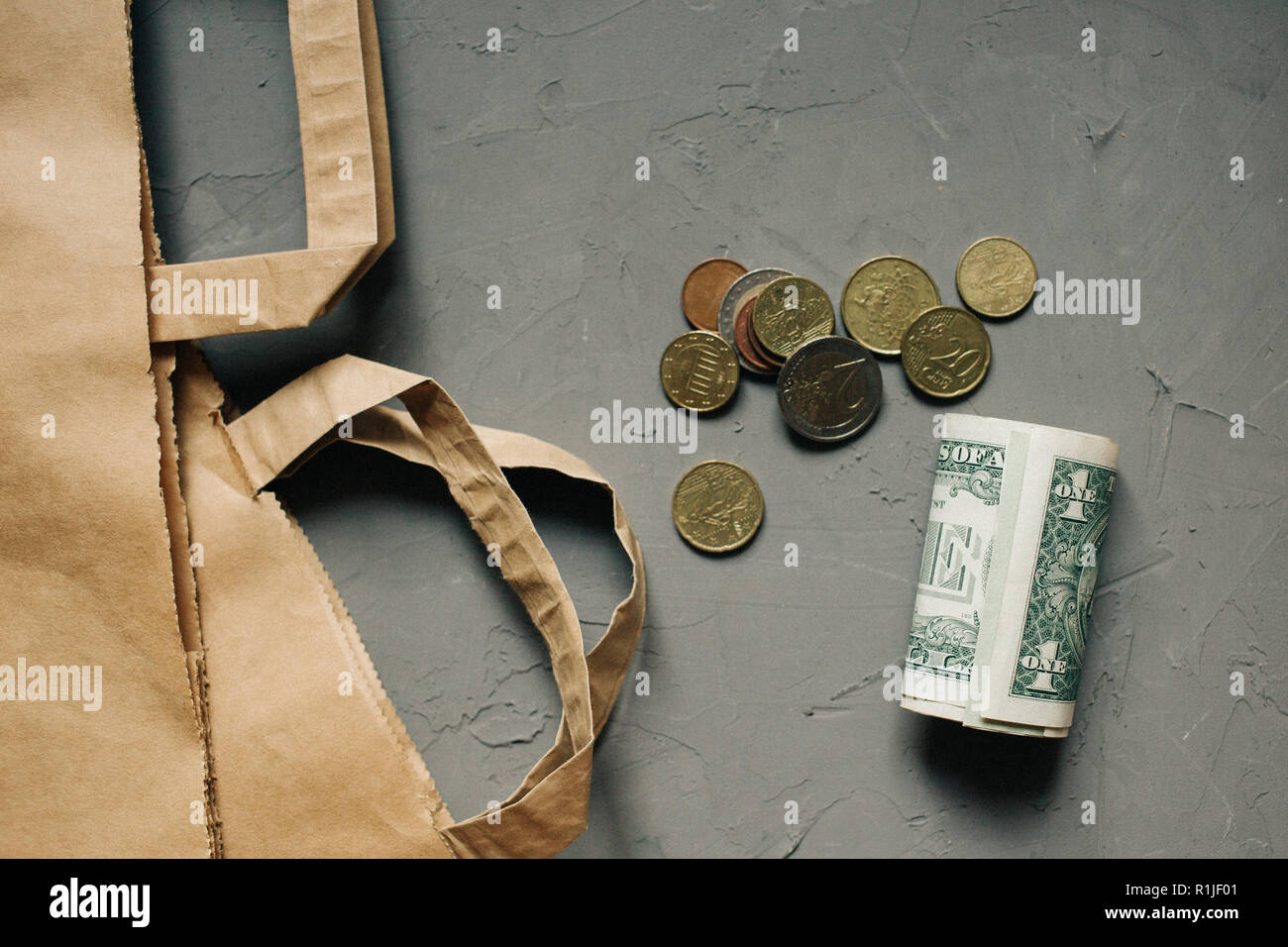 Cash dollars money, euro coins with a Kraft package on gray Stock Photo ...