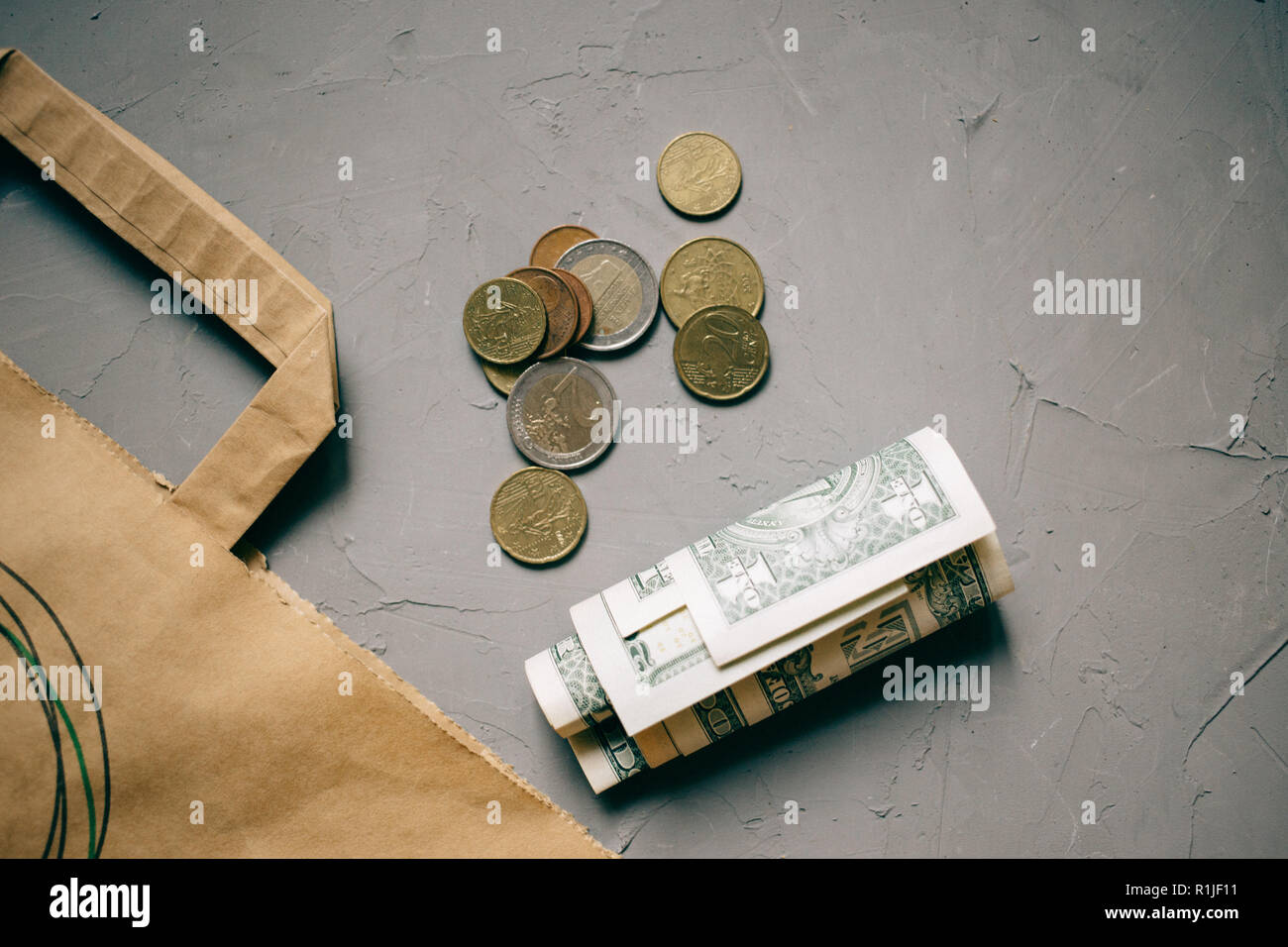 Cash dollars money, euro coins with a Kraft package on gray Stock Photo ...