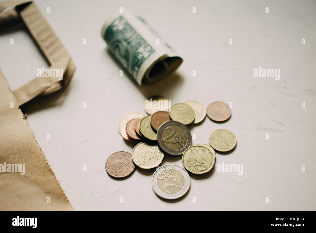 Cash dollars money, euro coins with a Kraft package on white Stock ...