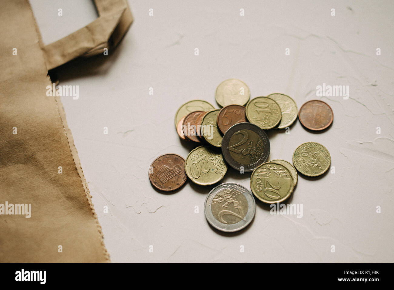 Cash money, euro coins with a Kraft package on white background Stock ...