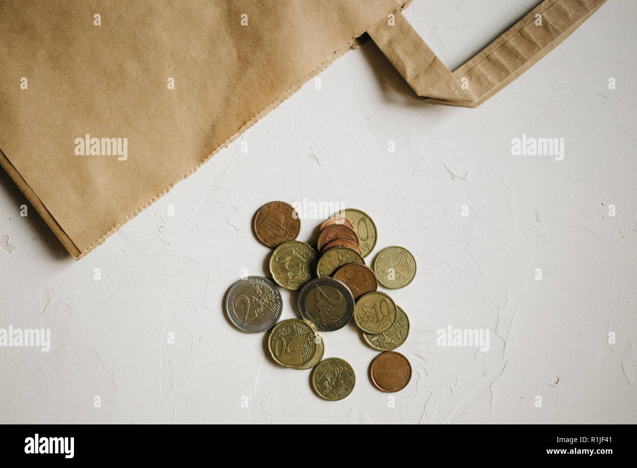 Cash money, euro coins with a Kraft package on white background Stock ...