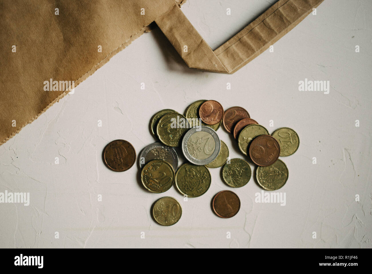 Cash money, euro coins with a Kraft package on white background Stock ...