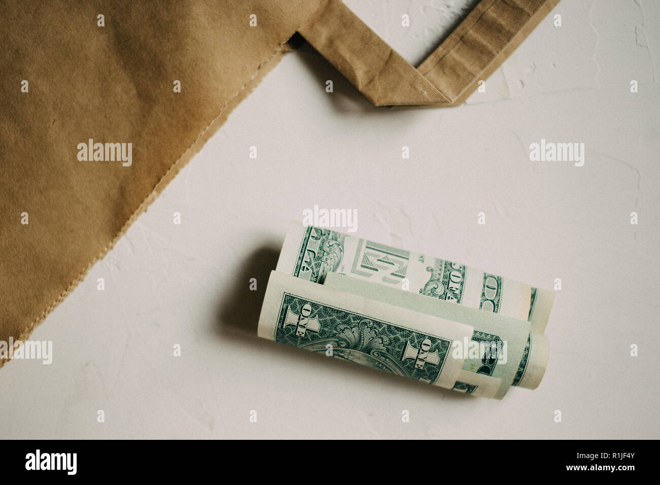 Cash dollars money, with a Kraft package on white background Stock ...