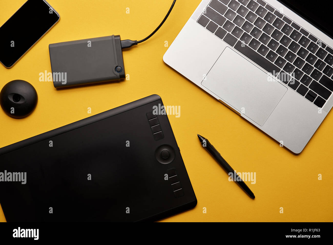 top view of various graphic designer gadgets on yellow surface Stock ...