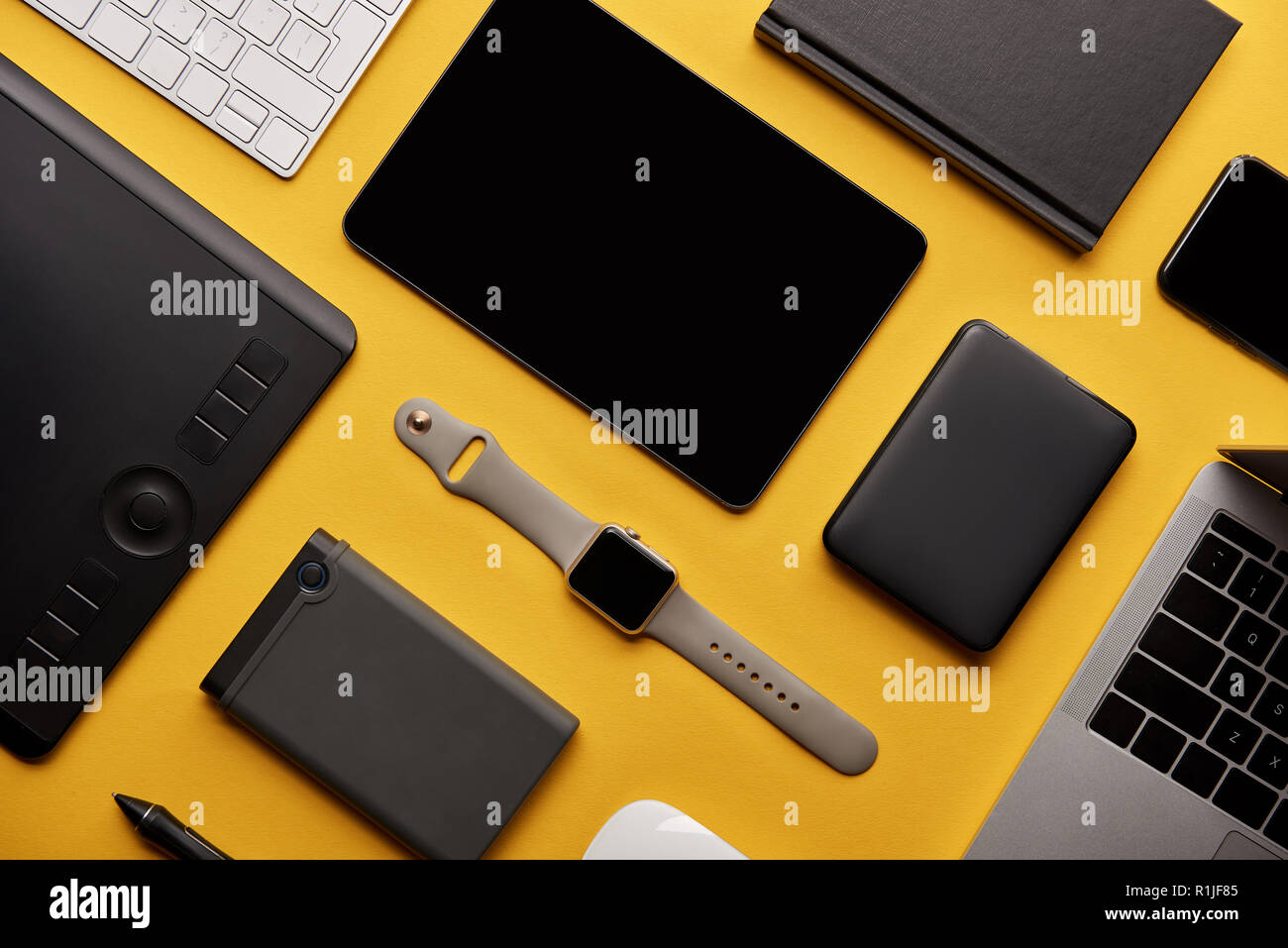 flat lay with different wireless devices on yellow surface Stock Photo ...