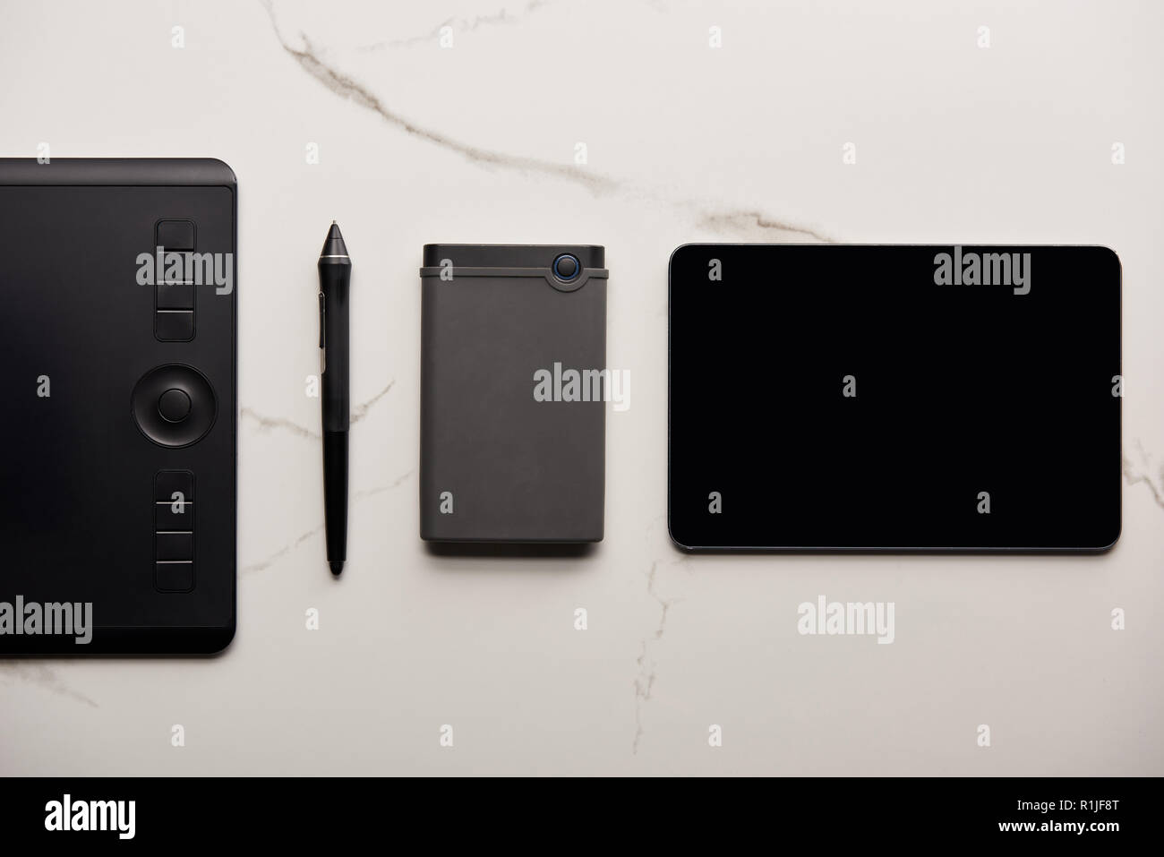 top view of graphics and digital tablet with portable hdd on white ...