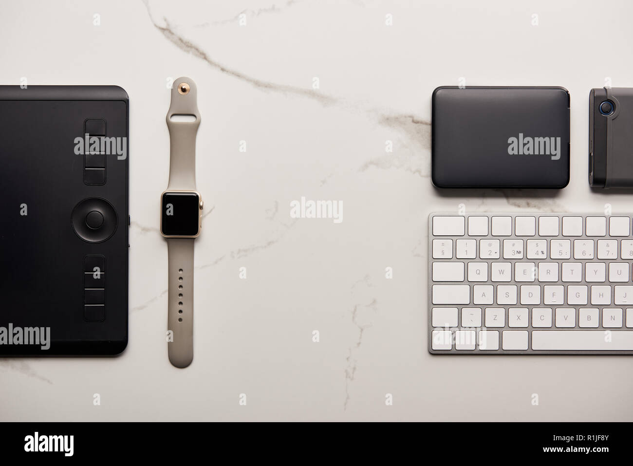flat lay with graphics tablet with portable hdd, smart watch and ...
