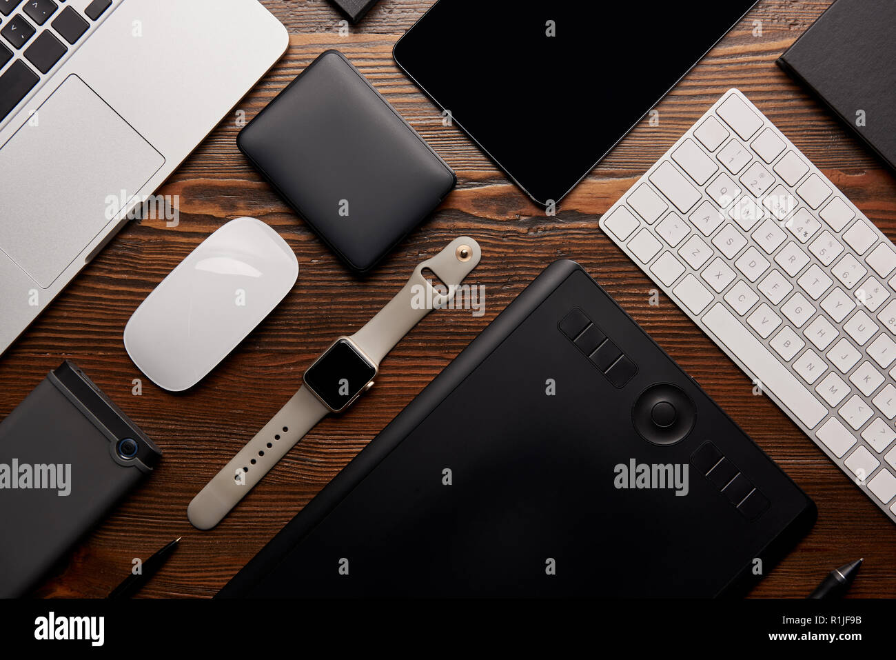 flat lay with different devices on wooden workplace Stock Photo - Alamy