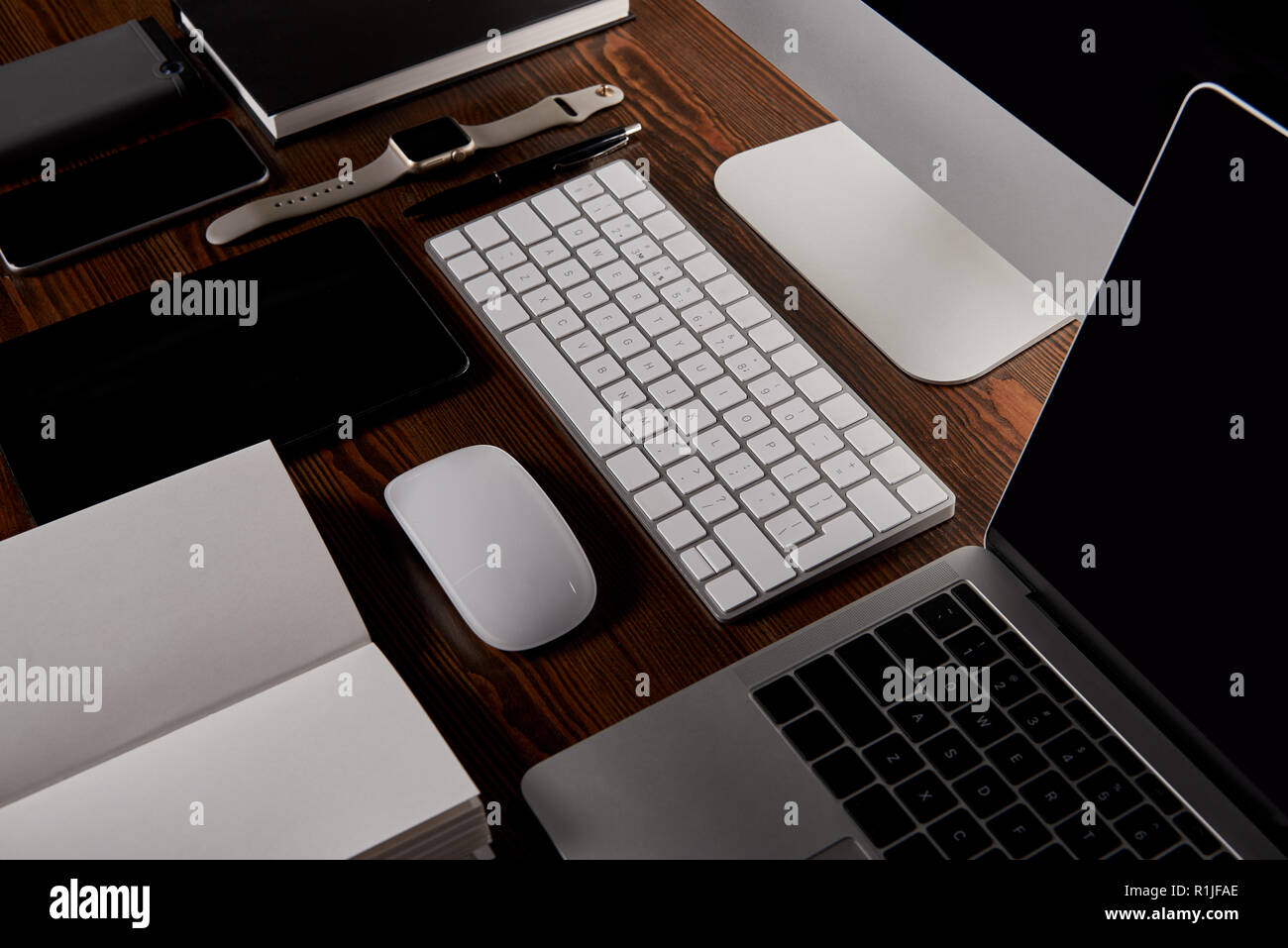 modern workplace with various devices on wooden table Stock Photo - Alamy