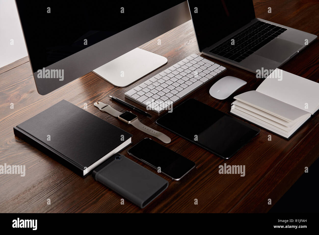 modern workplace with various gadgets on wooden table Stock Photo - Alamy