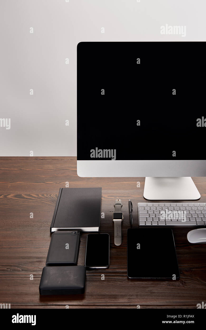 monoblock computer with various devices on wooden table isolated on ...