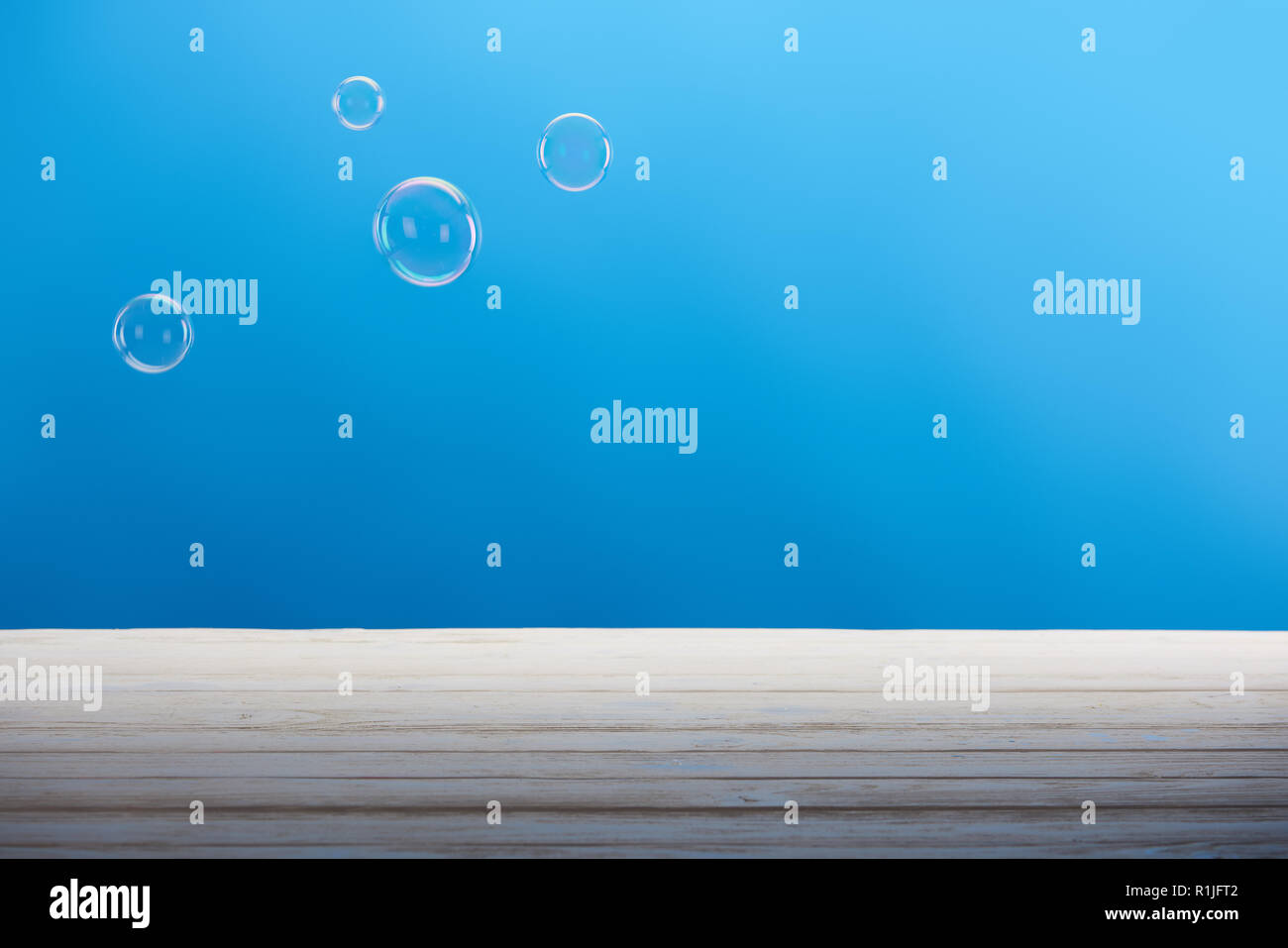 clean soap bubbles and white surface on blue background Stock Photo - Alamy
