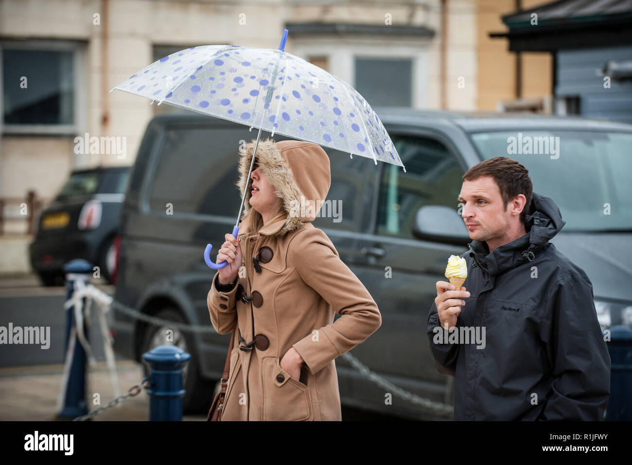 People going about their daily life in the rain Stock Photo - Alamy