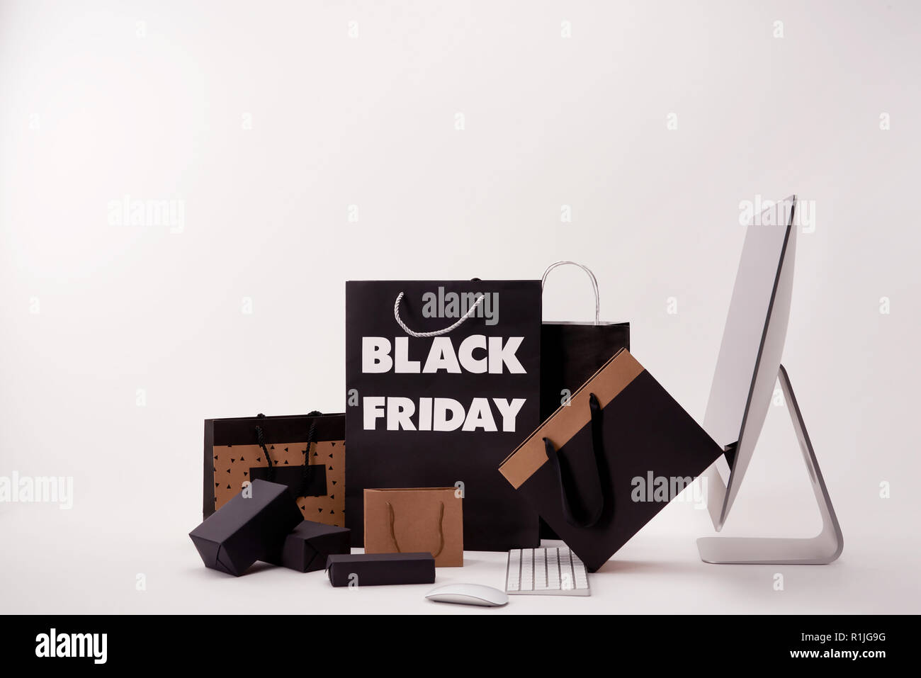 side view of computer and various boxes with shopping bags with black ...
