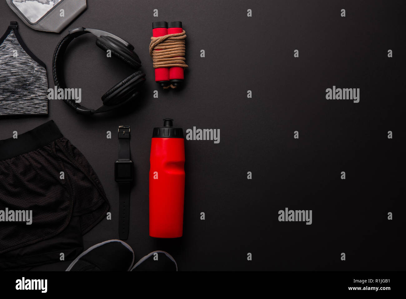 view from above of arranged set of gym equipment isolated on black ...