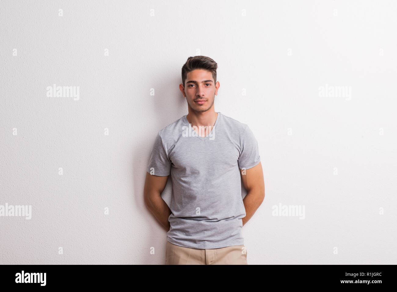 A cheerful young hispanic man standing in a studio Stock Photo - Alamy