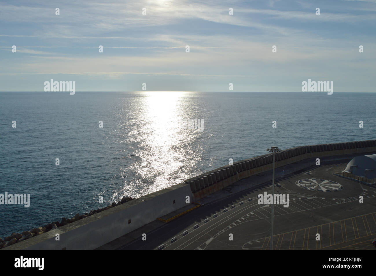 Beautiful sunset and silver path on the sea, blue clouds in the sky ...