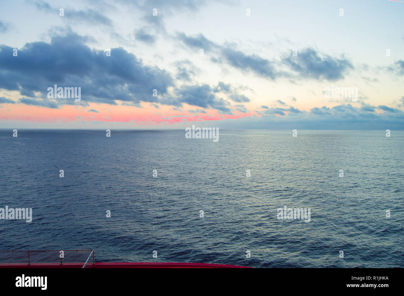 Beautiful sunset and silver path on the sea, blue clouds in the sky ...