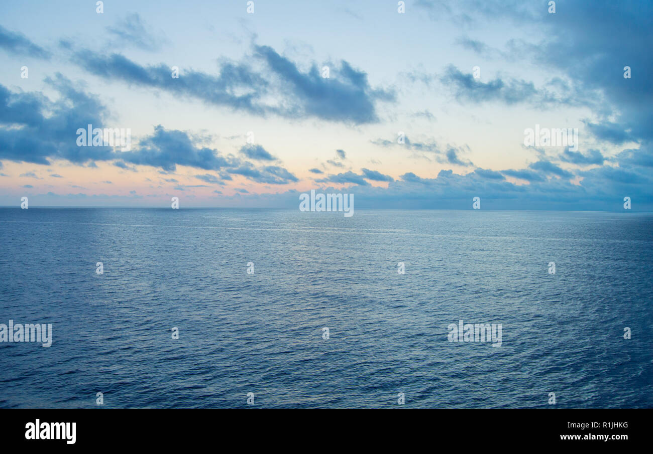 Beautiful sunset and silver path on the sea, blue clouds in the sky ...