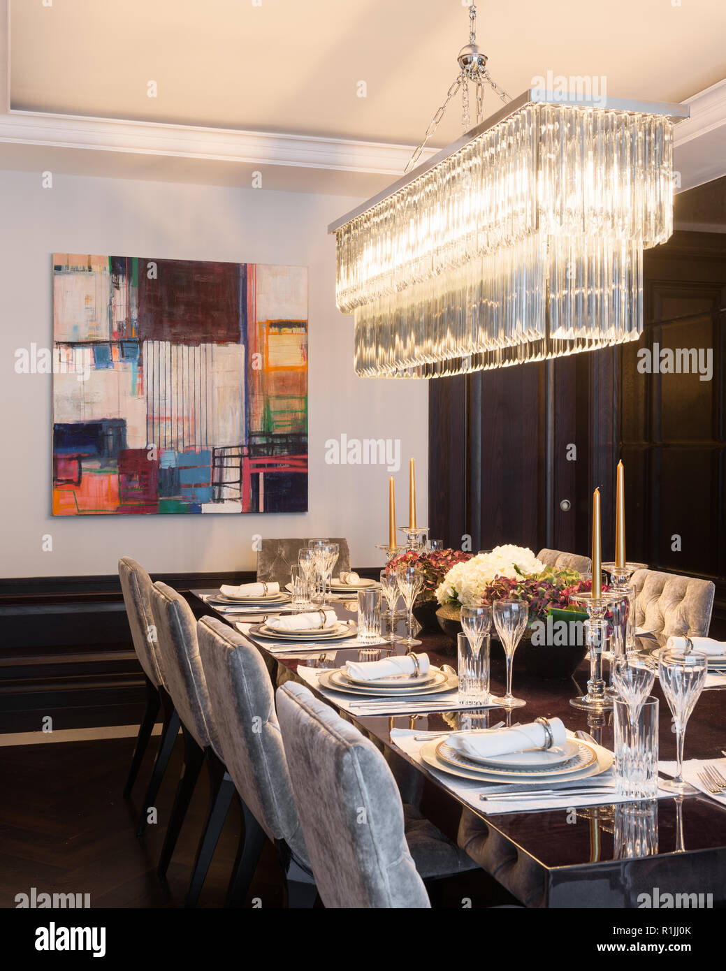 Pendant light over set dining table Stock Photo - Alamy