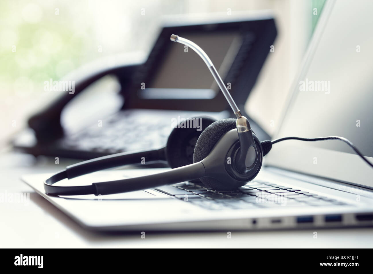 VOIP headset headphones telephone and laptop concept for communication ...