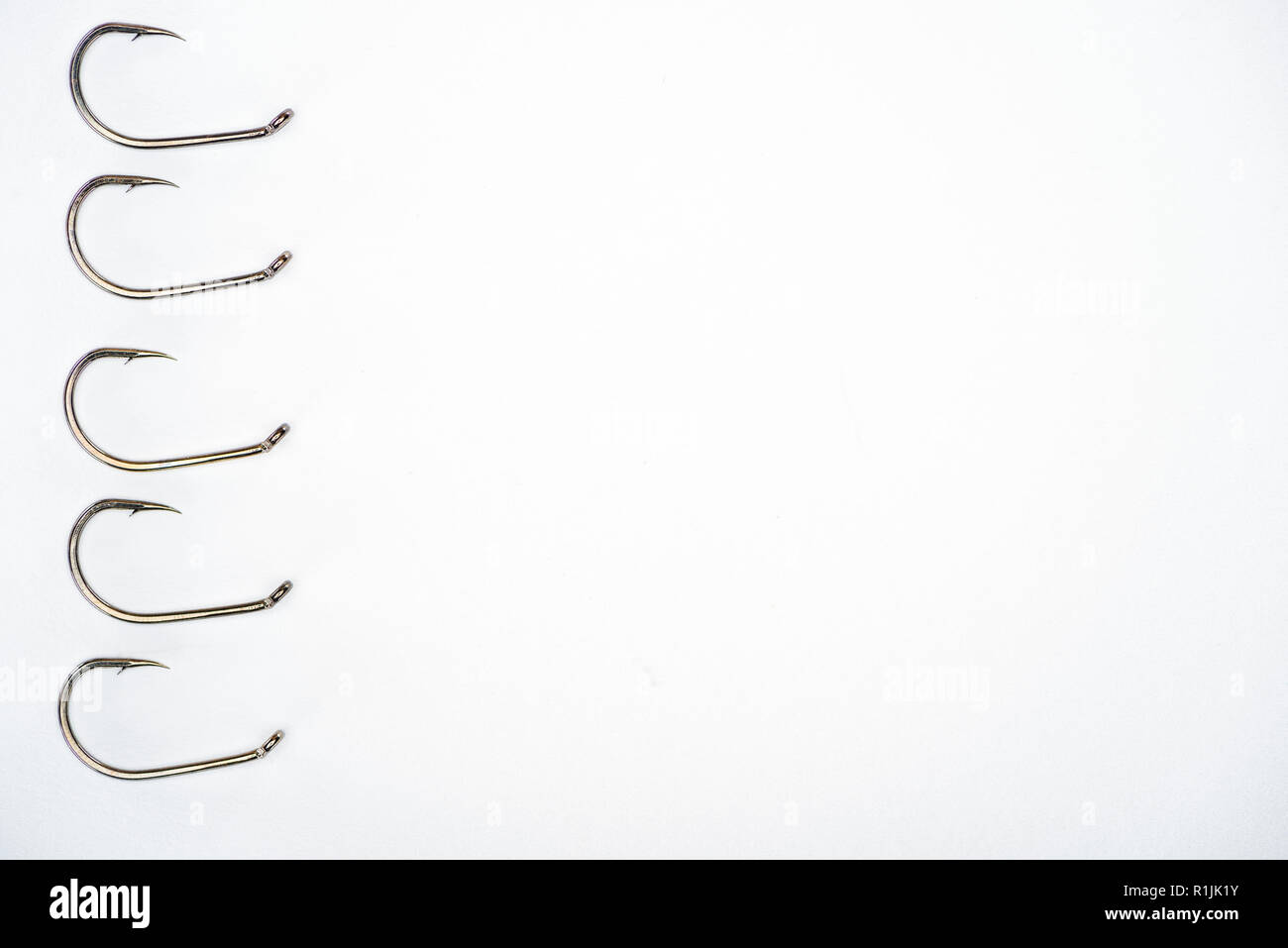 top view of fishing hooks placed in row isolated on white Stock Photo ...