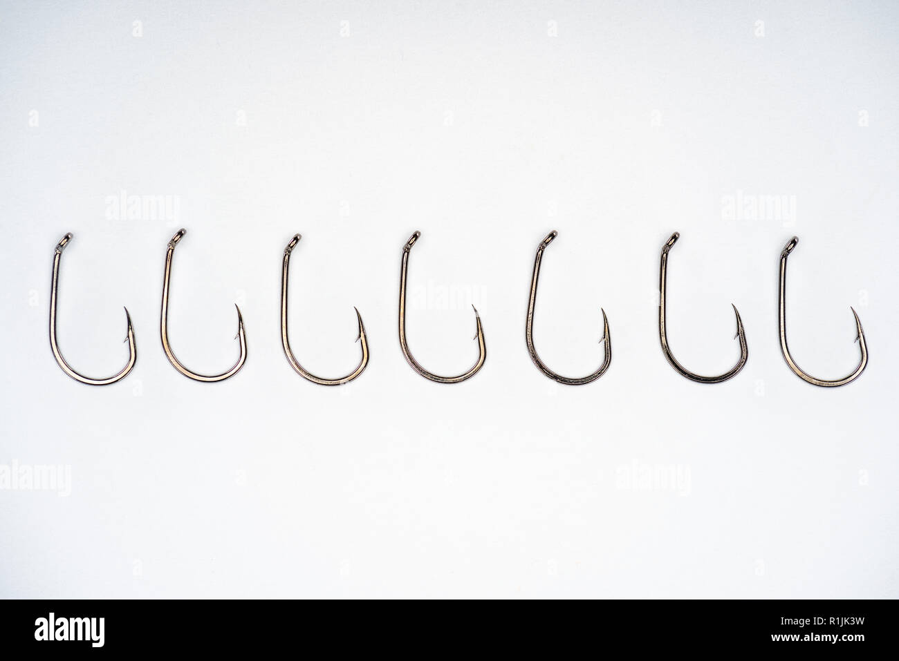 top view of fishing hooks placed in row isolated on white Stock Photo ...