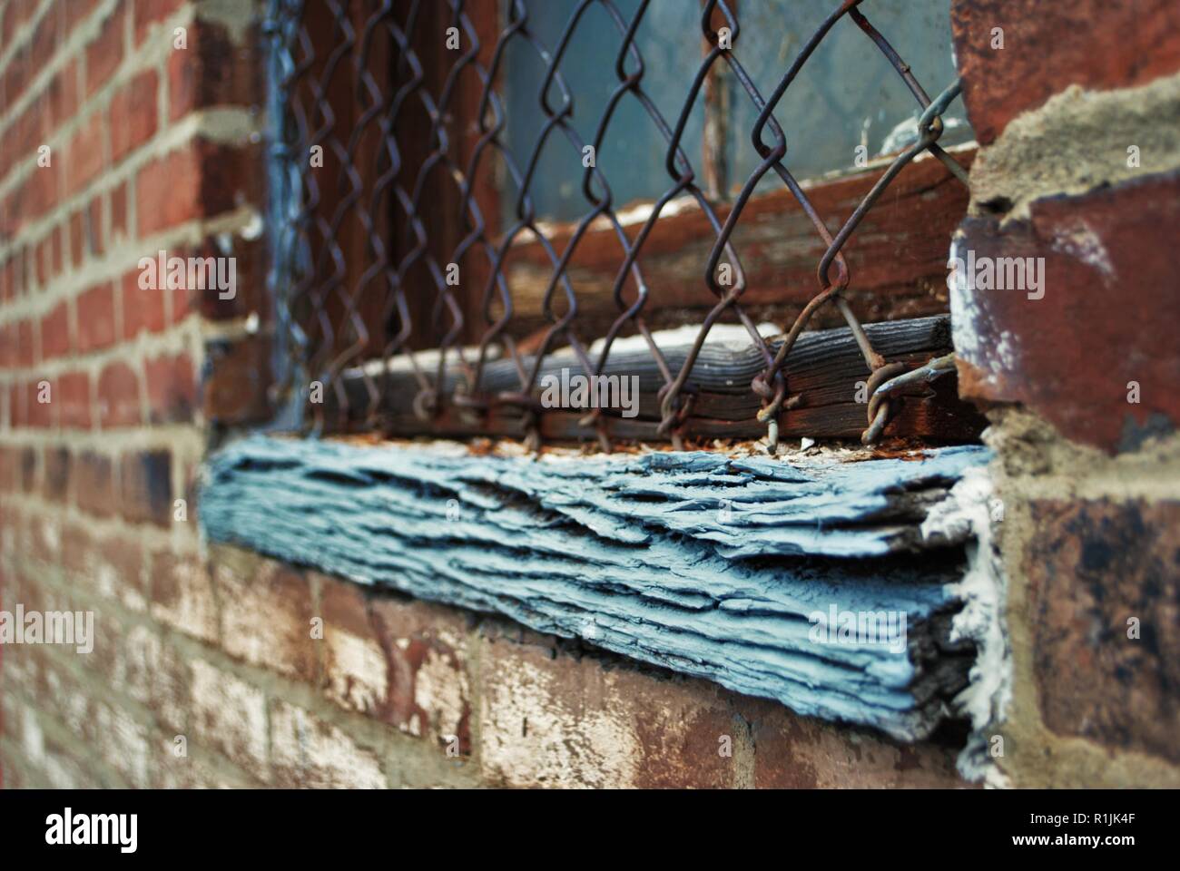 Close up of a dirty broken boarded up window sill on an abandoned ...