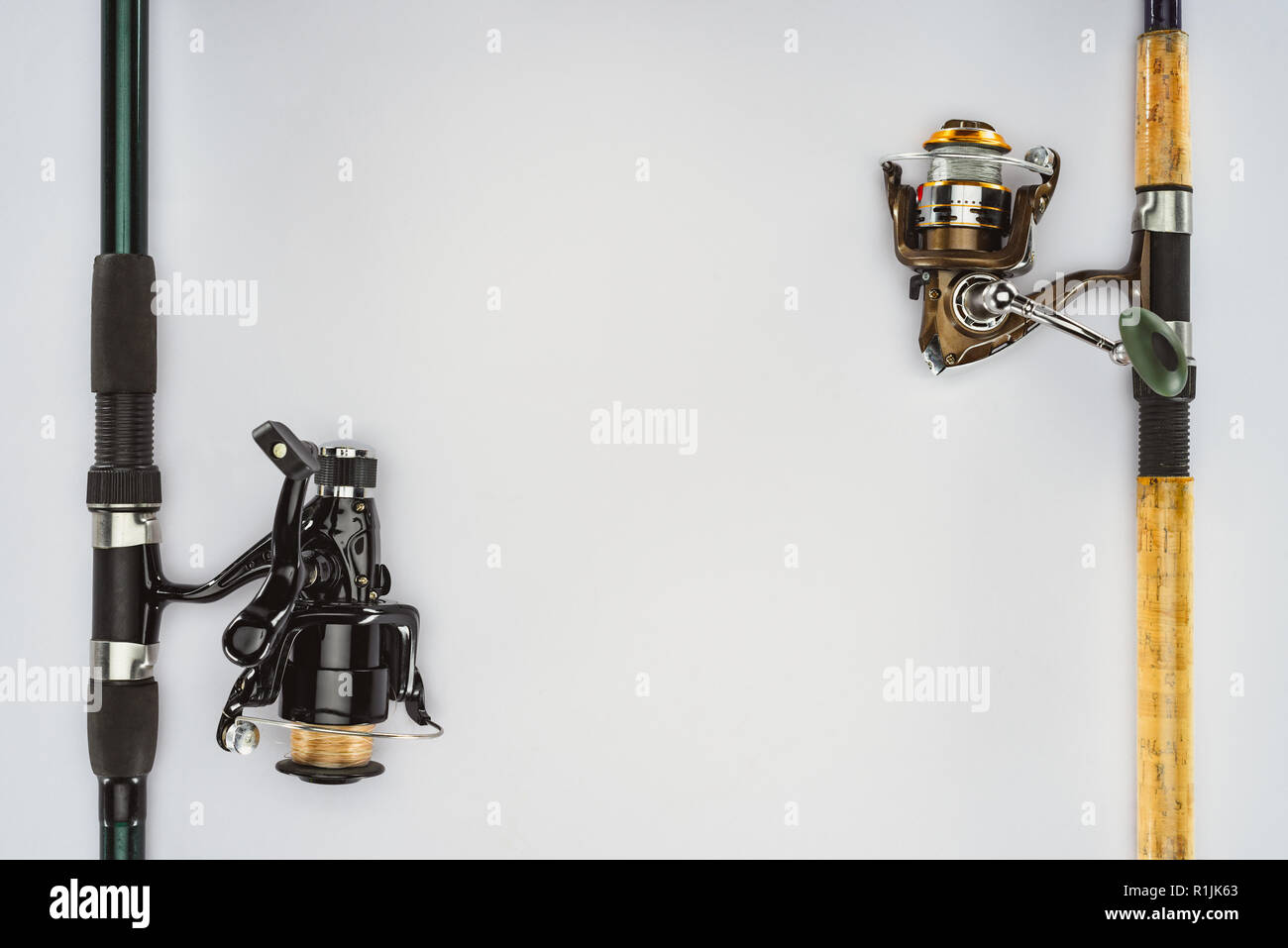 top view of two arranged fishing rods isolated on white, minimalistic ...